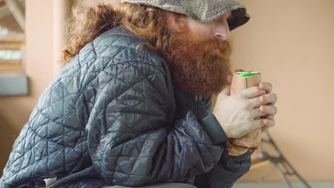 Homeless Man outdoors in blue jacket hol... | Stock Video | Pond5