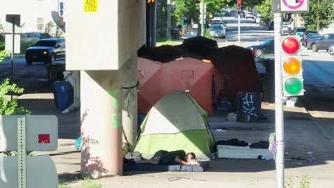 Homeless man sleeping under highway over... | Stock Video | Pond5