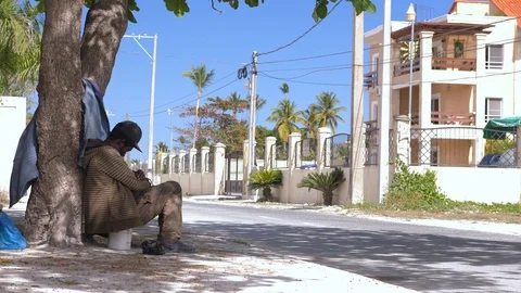 Homeless man sleeping under tree at the ... | Stock Video | Pond5