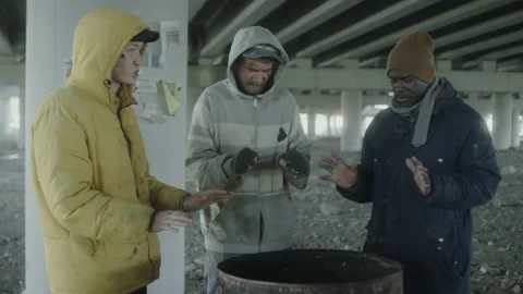 Homeless People Talking around Fire Barr... | Stock Video | Pond5