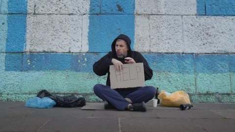 homeless poor young man sitting on the g... | Stock Video | Pond5