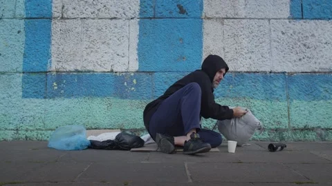 homeless poor young man sitting on the g... | Stock Video | Pond5