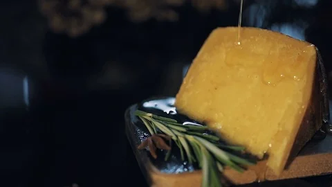 Honey dropping on cheese. Slow motion | Stock Video | Pond5