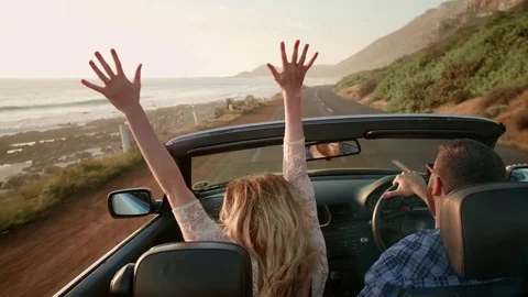 Honeymoon couple driving along the ocean... | Stock Video | Pond5