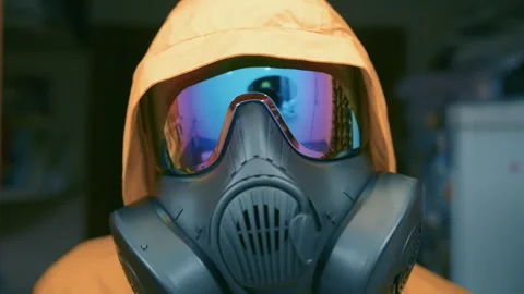 Hooded Figure in Gas Mask and Yellow Haz... | Stock Video | Pond5