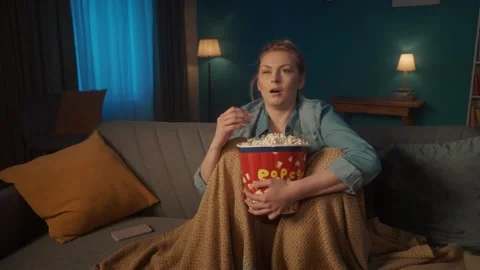 Horror film. Shocked young woman watchin... | Stock Video | Pond5