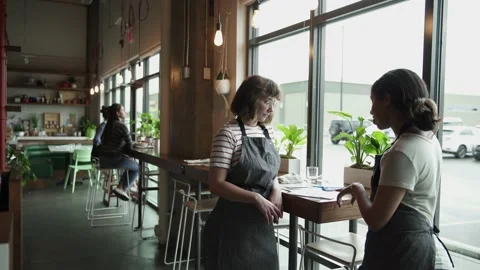 Hostess and waitress discussing seating ... | Stock Video | Pond5