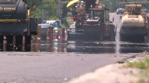 Hot asphalt road paving on summer day in... | Stock Video | Pond5