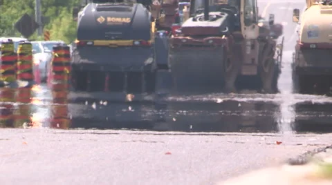 Hot asphalt road paving on summer day in... | Stock Video | Pond5