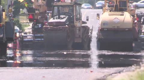 Hot asphalt road paving on summer day in... | Stock Video | Pond5
