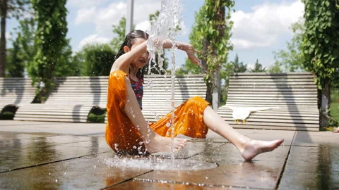On a hot day, a girl sitting on the slab... | Stock Video | Pond5