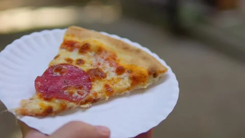 A hot slice of pepperoni pizza being hel... | Stock Video | Pond5