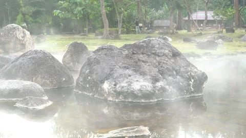 Hot steam floating over hot spring water... | Stock Video | Pond5