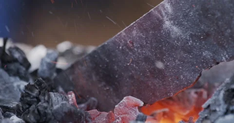 Hot steel in fire flames. Making a knife... | Stock Video | Pond5