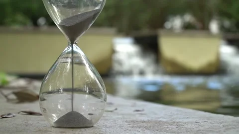 Hourglass with sand flowing with a water... | Stock Video | Pond5