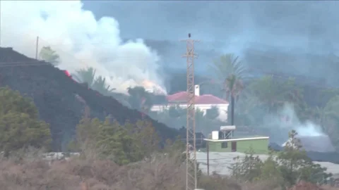 House burns as lava flows from La Palma ... | Stock Video | Pond5