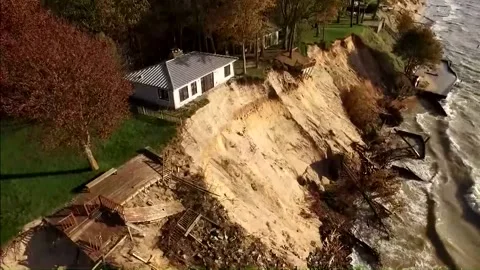 HOUSE FALLS INTO SEA FROM EROSION ALONG ... | Stock Video | Pond5
