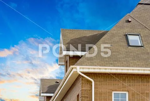 Photograph: House with a gable roof window chimney on the roof of the ...