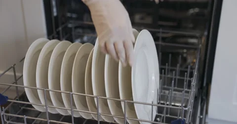 Housewife taking out clean plates from d... | Stock Video | Pond5