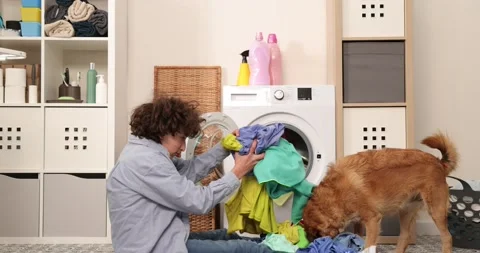 Housework. Boy doing laundry at home loa... | Stock Video | Pond5