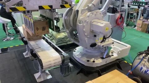 Huge industrial robotic arm packaging ap... | Stock Video | Pond5