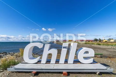 Huge letters form the word Chile on the beach of the Strait of Magellan ...