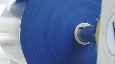 huge roll of blue adhesive tape turns on... | Stock Video | Pond5