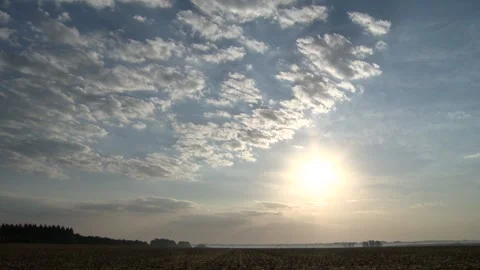 Huge sky moving with a field on the back... | Stock Video | Pond5
