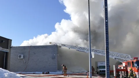 Huge structure fire during daylight | Stock Video | Pond5