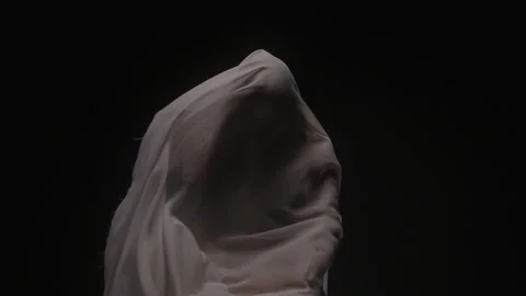 Human Figure Under a White Veil in a Stu... | Stock Video | Pond5