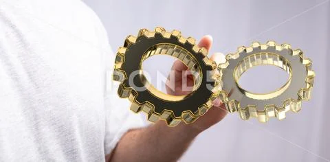 Photograph: Human hand showing cogs and gear wheel mechanisms #163172052