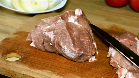 Human hands cut the meat with a knife. | Stock Video | Pond5