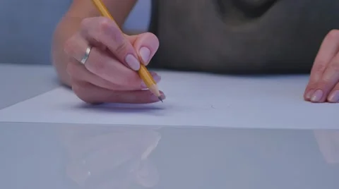 Human hands with pencil writing on paper... | Stock Video | Pond5