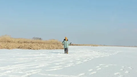 Humotous video little girl in warm blue ... | Stock Video | Pond5