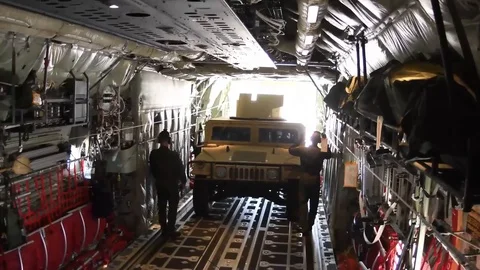 Humvee is being unload from Lockheed Mar... | Stock Video | Pond5