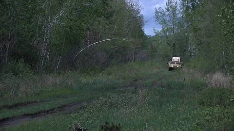 Humvee vehicle drive through forest road... | Stock Video | Pond5