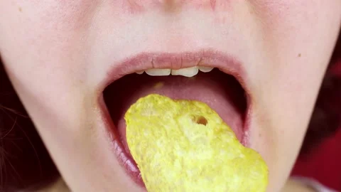 Hungry young woman chewing potato chips.... | Stock Video | Pond5