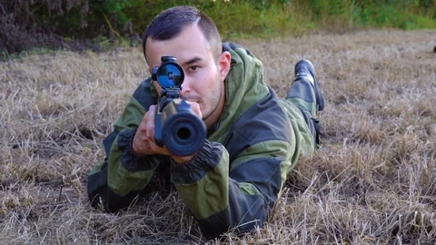 Hunter aiming a gun at wild animals | Stock Video | Pond5