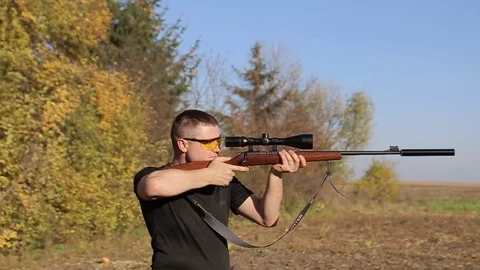 hunter, aiming for a rifle, a sniper | Stock Video | Pond5