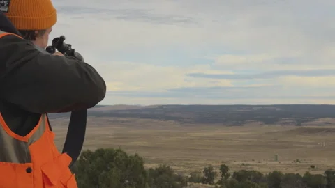 Hunter with orange identification pointi... | Stock Video | Pond5