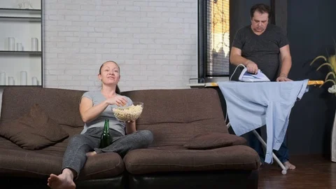 husband is angry at his wife watching TV... | Stock Video | Pond5