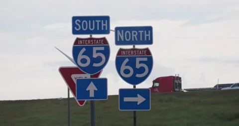I-65 traffic behind road signs | Stock Video | Pond5