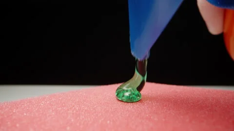 I drip green gel onto a red dishwashing ... | Stock Video | Pond5