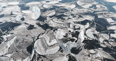 Ice patterns on a frozen tarn on the sum... | Stock Video | Pond5