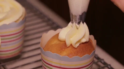 Icing being applied to a cupcake | Stock Video | Pond5