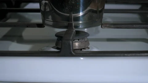 Ignite the gas burner on the stove. | Stock Video | Pond5