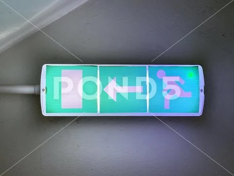 Photograph: Illuminated emergency exit sign, taken on stairs in a high ...