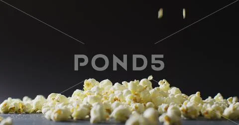Image of close up of popcorn falling on black background Stock Photo ...