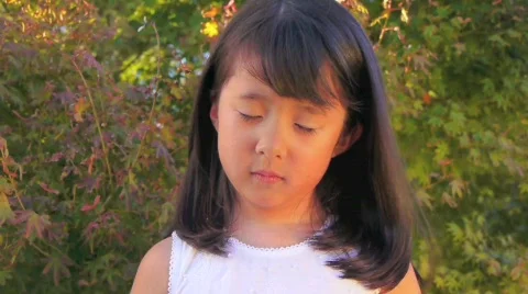 Imagine - Little girl with eyes closed | Stock Video | Pond5