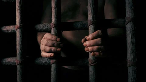 Imprisoned Man Holds Bars In Ancient Wor... | Stock Video | Pond5